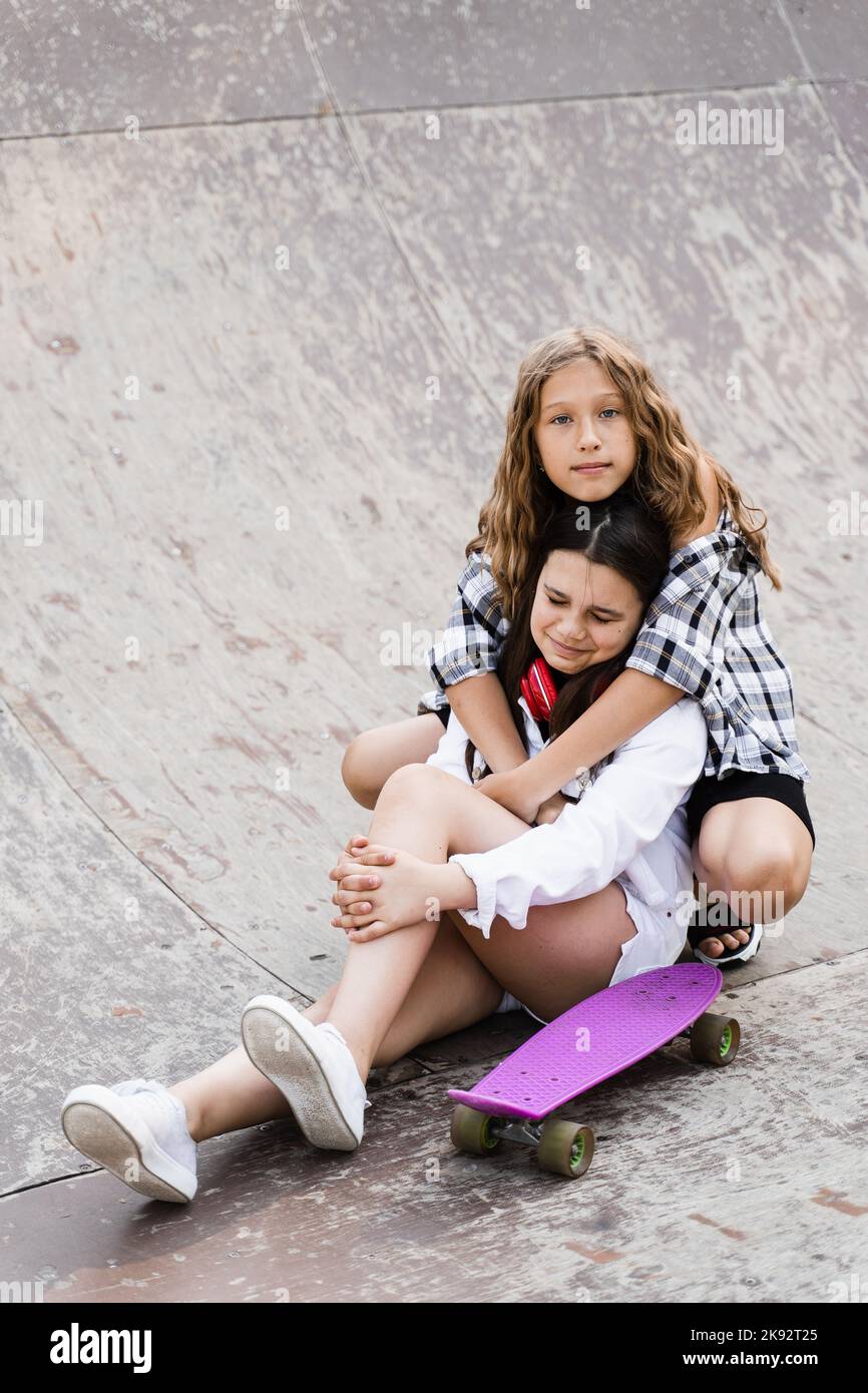 Falling from skateboard. Active children girls after fall from penny ...