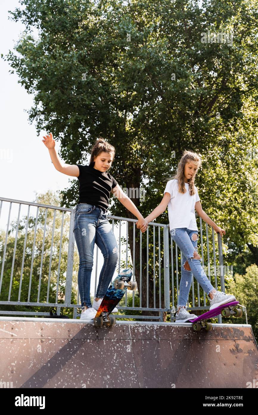 Children girls skating together. Friendship. Friends ready for ride on ...