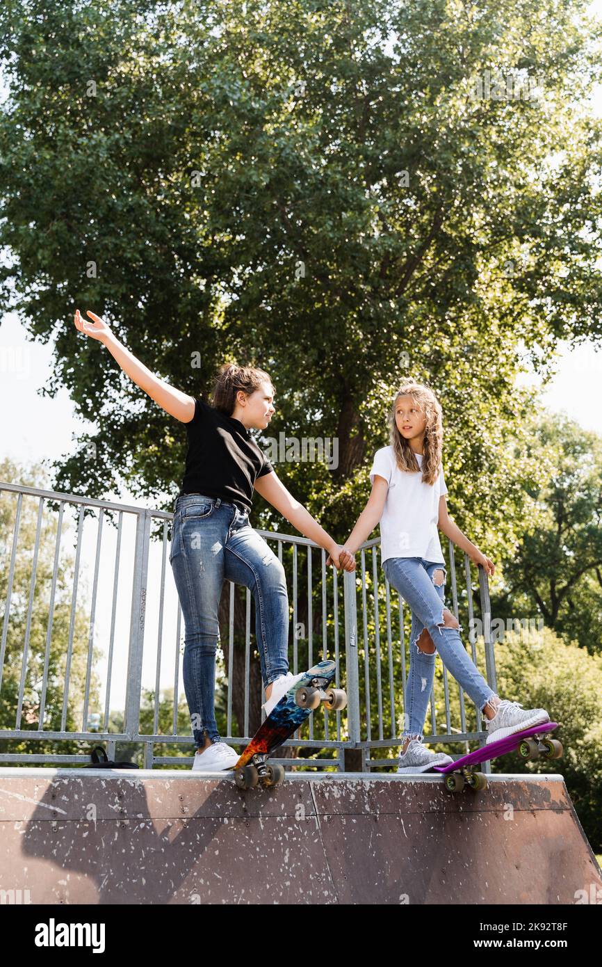 Children girls skating together. Friendship. Friends ready for ride on ...