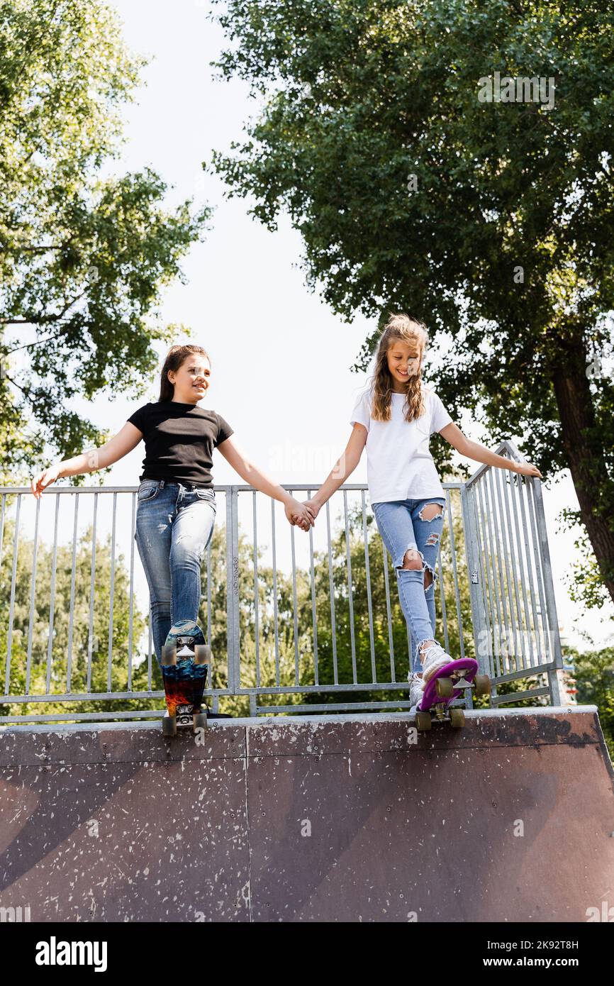 Children girls skating together. Friendship. Friends ready for ride on ...