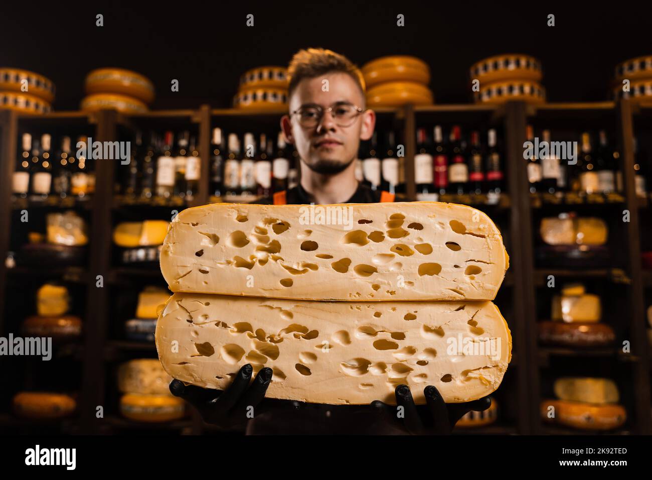 Handsome cheese sommelier with 2 half of yellow cheese wheel limited ...