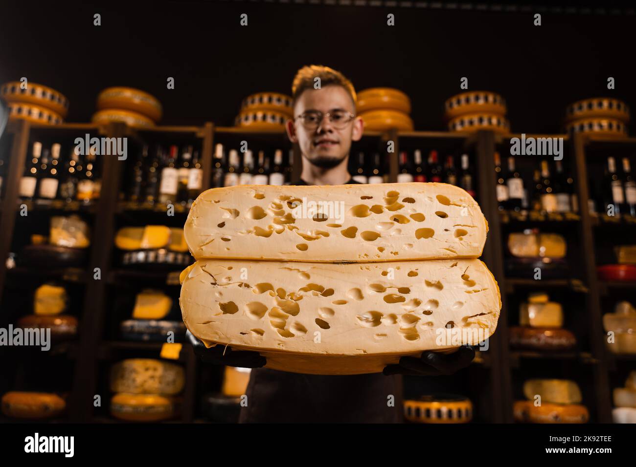 Handsome cheese sommelier with 2 half of yellow cheese wheel limited ...