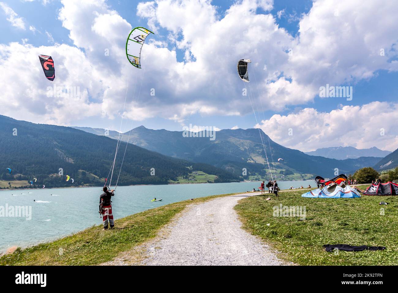 LATSCH, ITALY - AUG 1, 2009: people enjoy windsurfing at lake Levico in ...