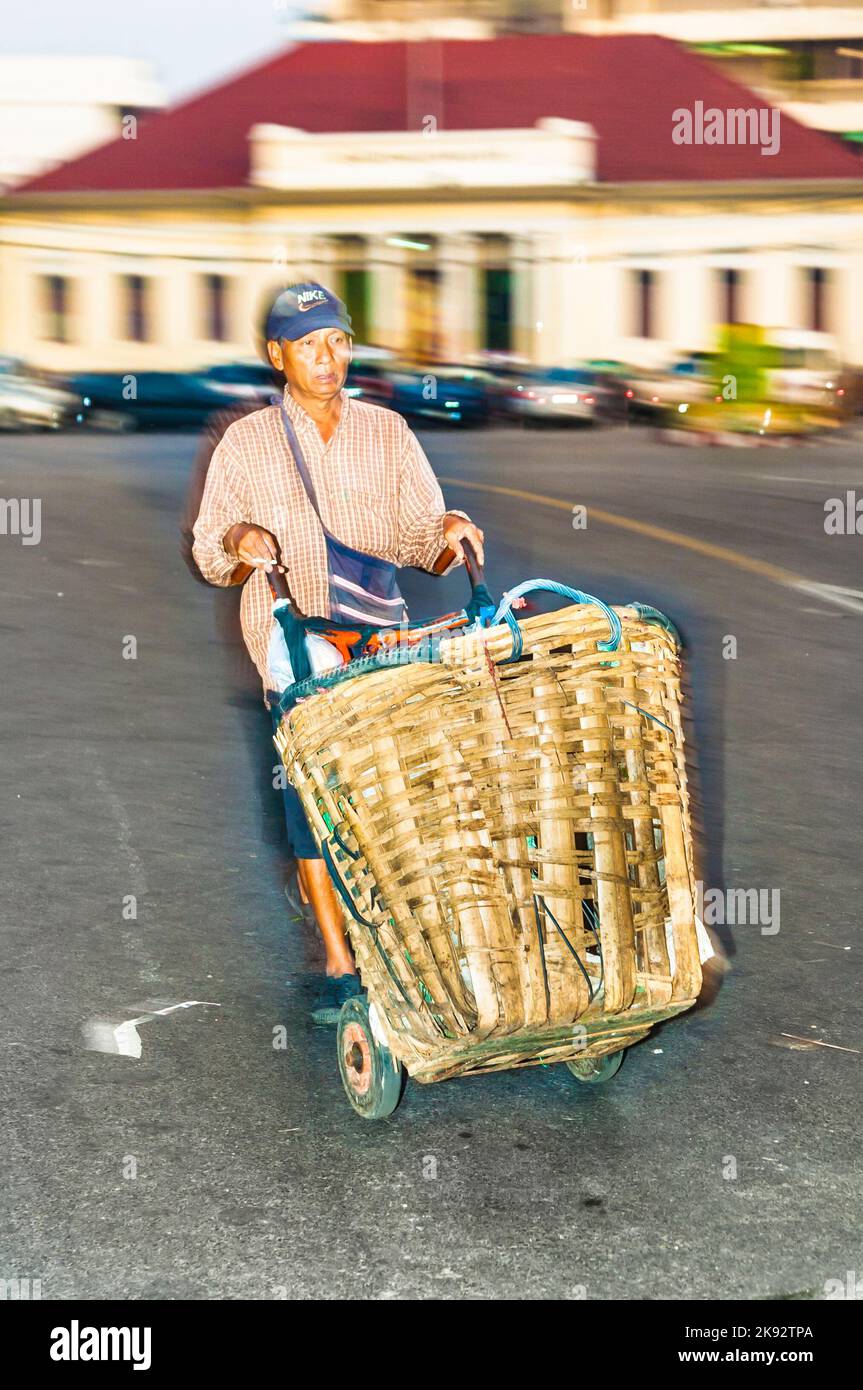 BANGKOK, THAILAND - DEC 23, 2009: man drives home with his barrow from ...