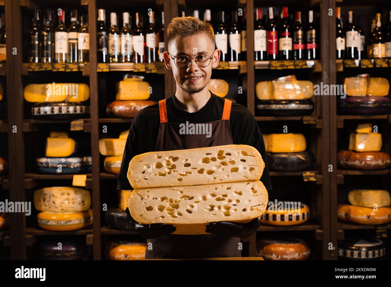 Handsome cheese sommelier with 2 half of yellow cheese wheel limited ...