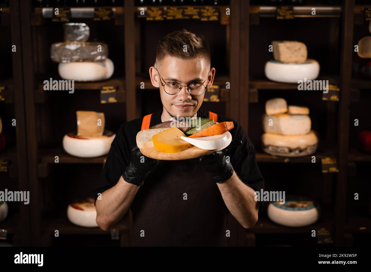 Cheese Sommelier holding plate with mix of young Gouda, young goat ...