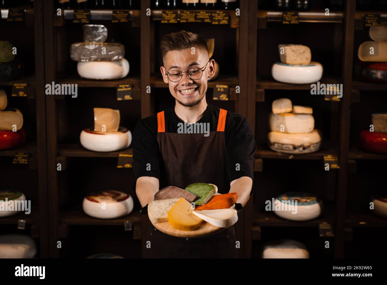 Cheese Sommelier holding plate with mix of young Gouda, young goat ...