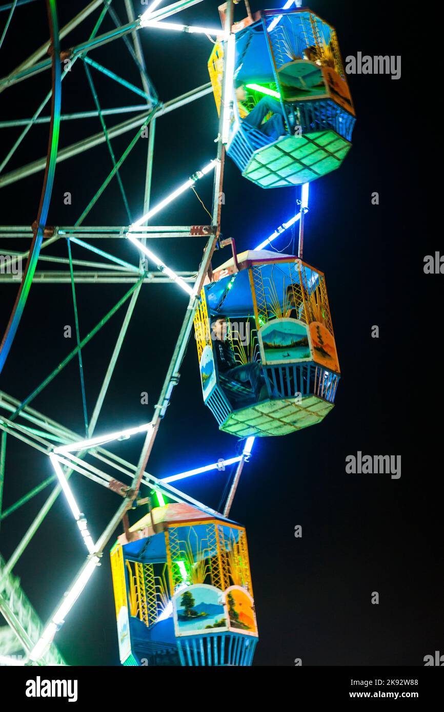 DELHI, INDIA - NOV 11, 2011: people enjoy the big wheel in the ...
