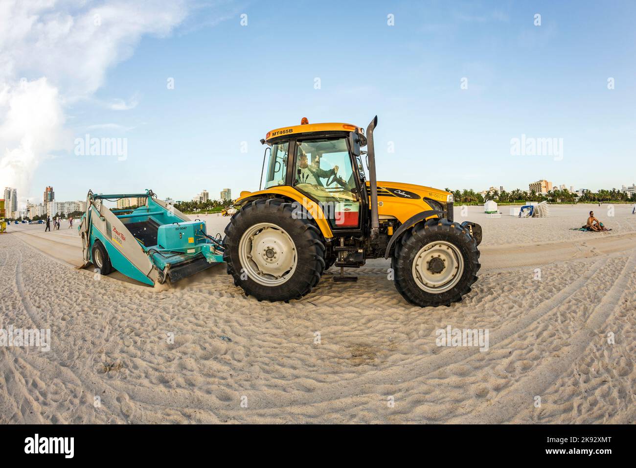 MIAMI, USA - AUG 20, 2014: man prepares the beach early morning with ...