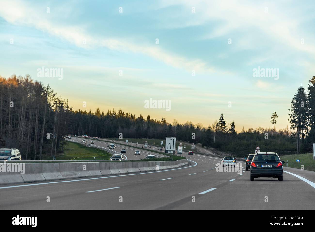 BURGAU, GERMANY - DEC 23, 2014: German highway A8 with cars in sunset ...