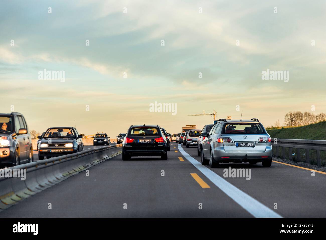 BURGAU, GERMANY - DEC 23, 2014: German highway A8 with cars in sunset ...