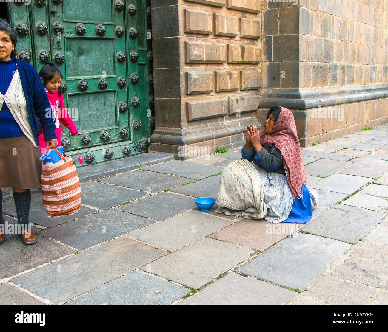 CUZCO, PERU - JAN 18, 2015: poor people beg for an alm in front of the ...