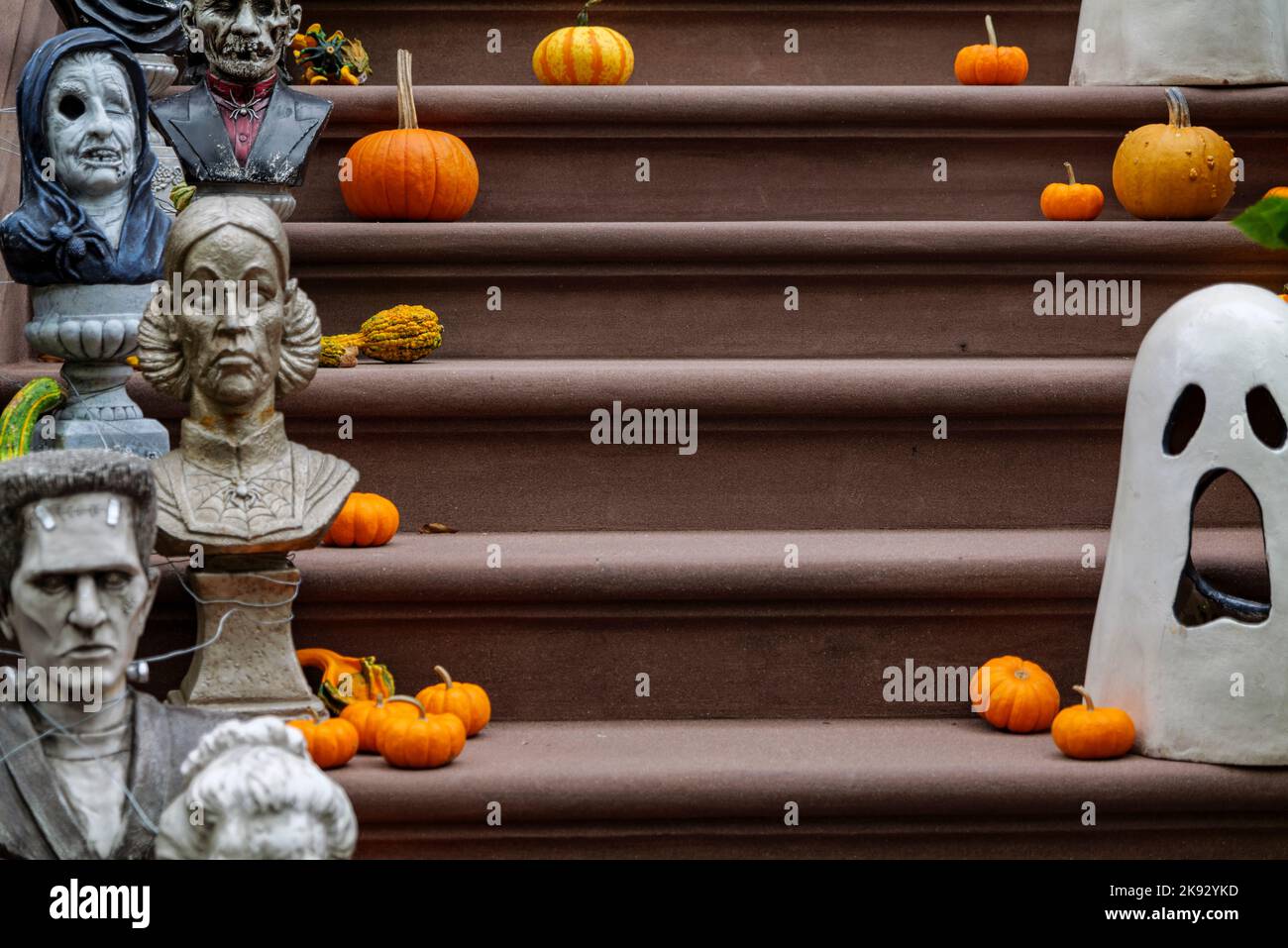 Assorted Halloween decorations guard the front steps of a house ...