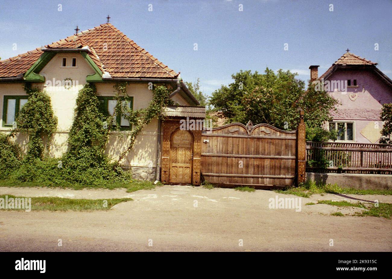 Old traditional houses with a hand-carved wooden gate in Covasna County ...
