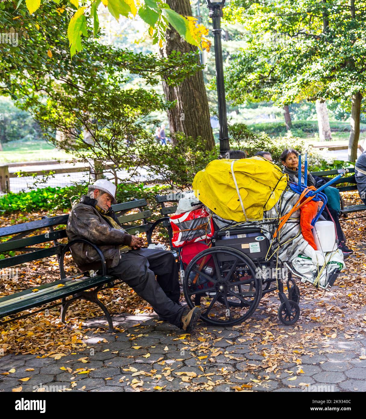 NEW YORK, USA - OCT 21, 2015: A homeless man sleeping in central park ...