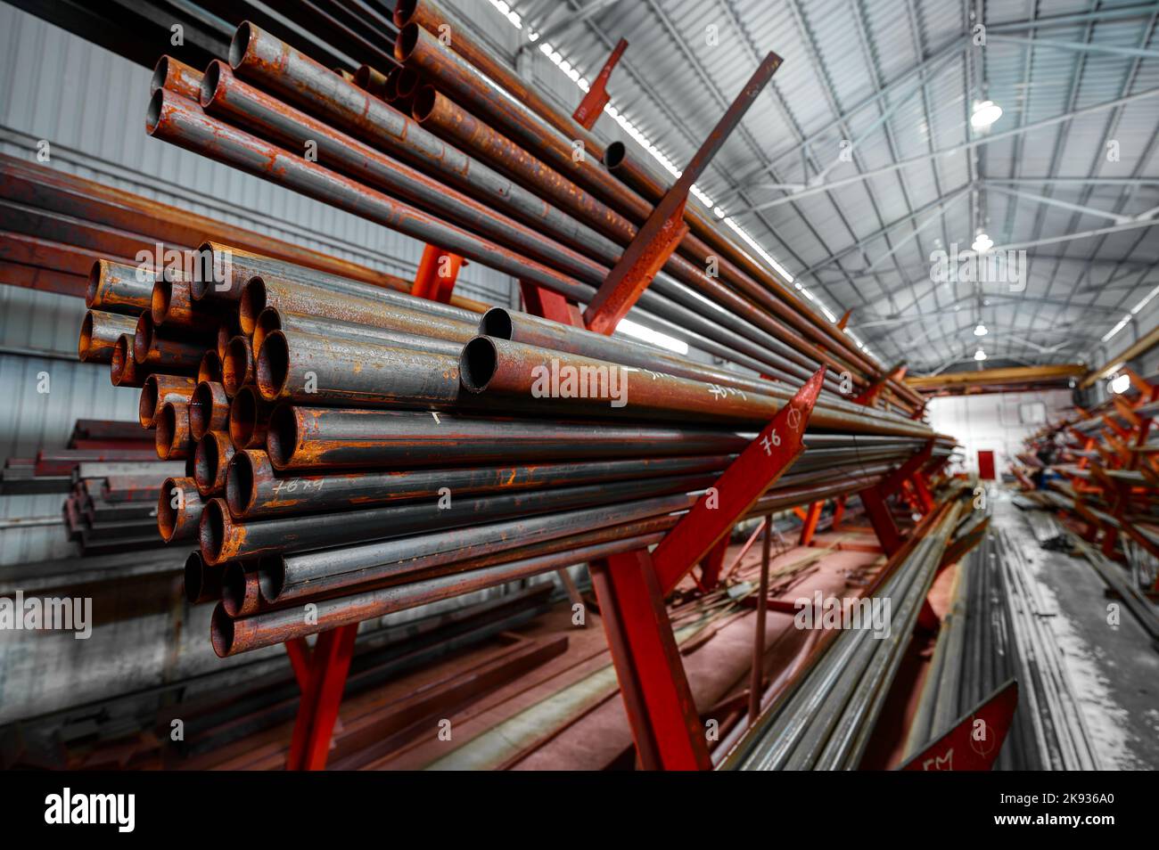 Cold rolled pipes stacked on shelving unit in plant storage Stock Photo ...