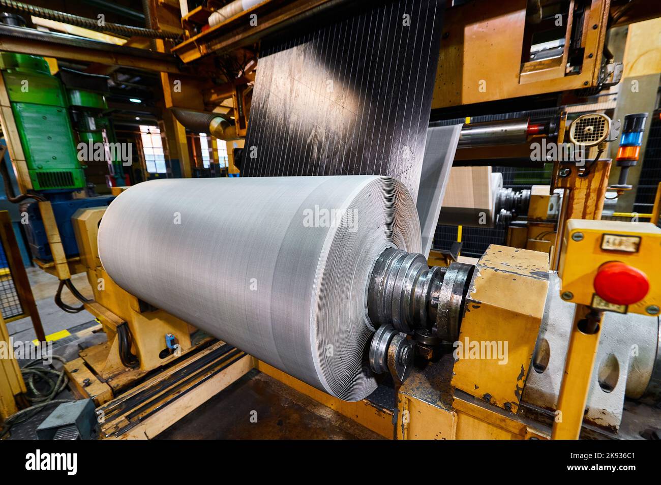 Rolling reinforced sheet on reel drum with rubber band Stock Photo - Alamy