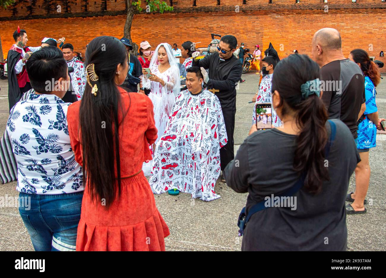 People look at barbers dressed in Chinese zombie, Count Dracula ...
