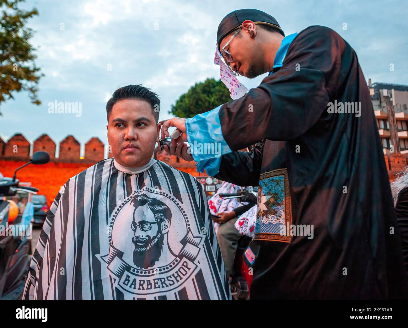 A barber dressed in Chinese zombie costume during the free haircut to ...