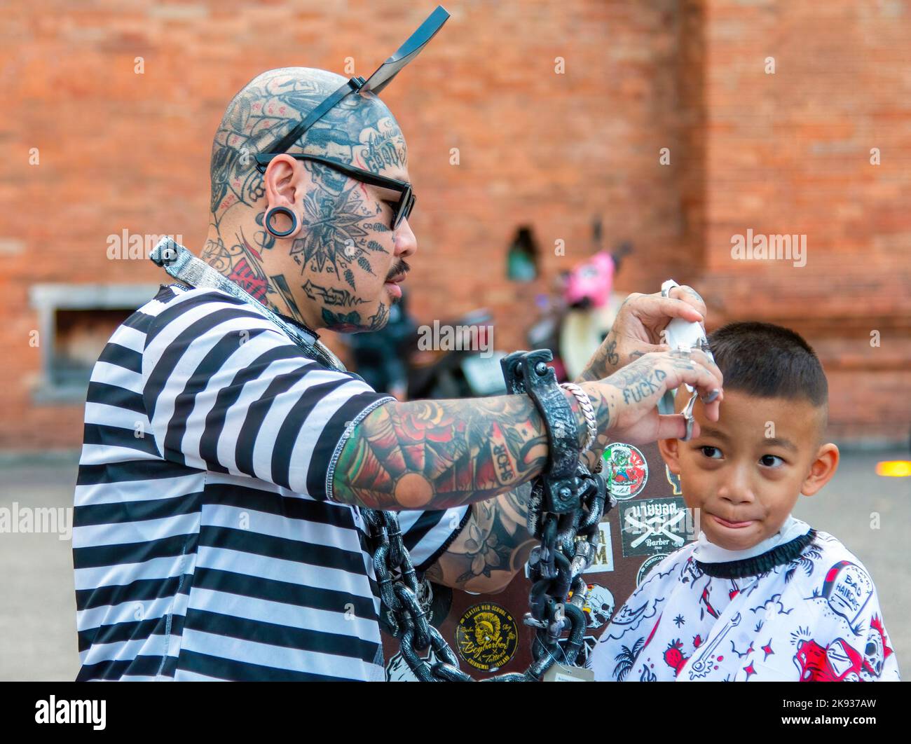 Chiang Mai, Thailand. 25th Oct, 2022. A barber dressed in a prisoner ...
