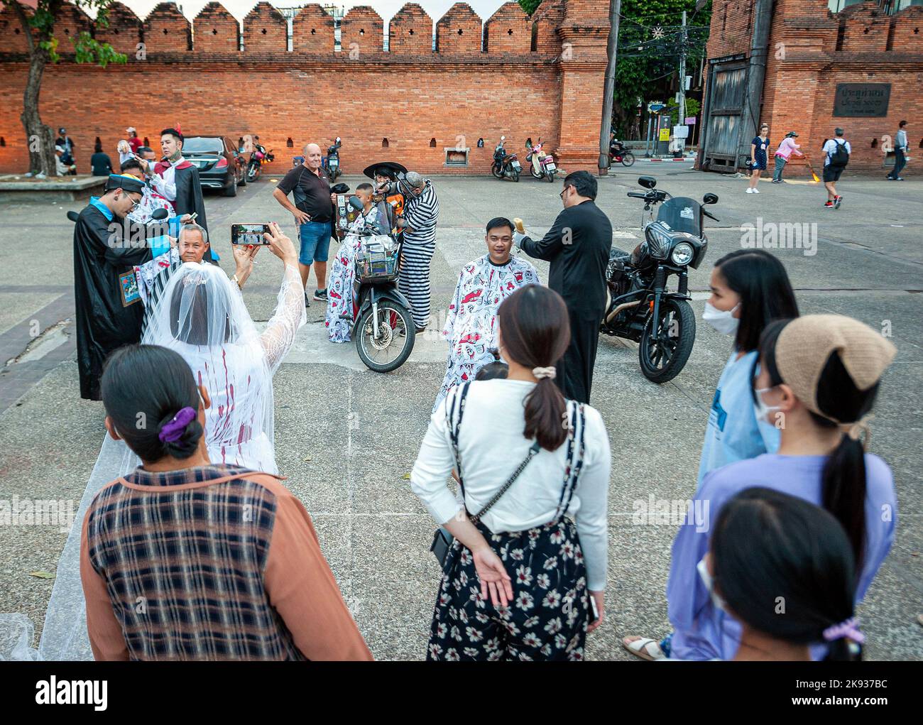 People look at barbers dressed in Chinese zombie, Count Dracula ...