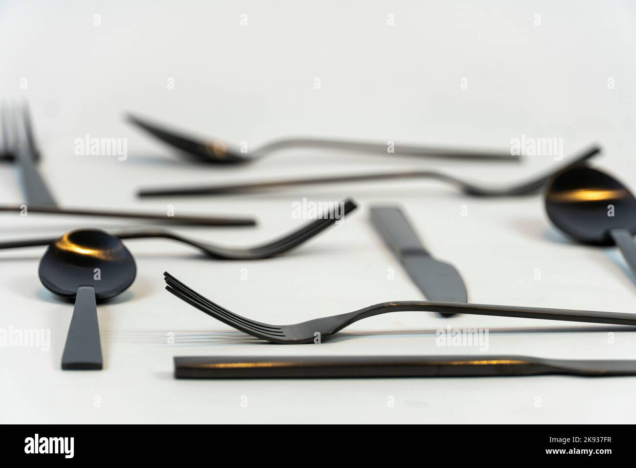 black metal forks and spoons on a white background, mexico Stock Photo ...