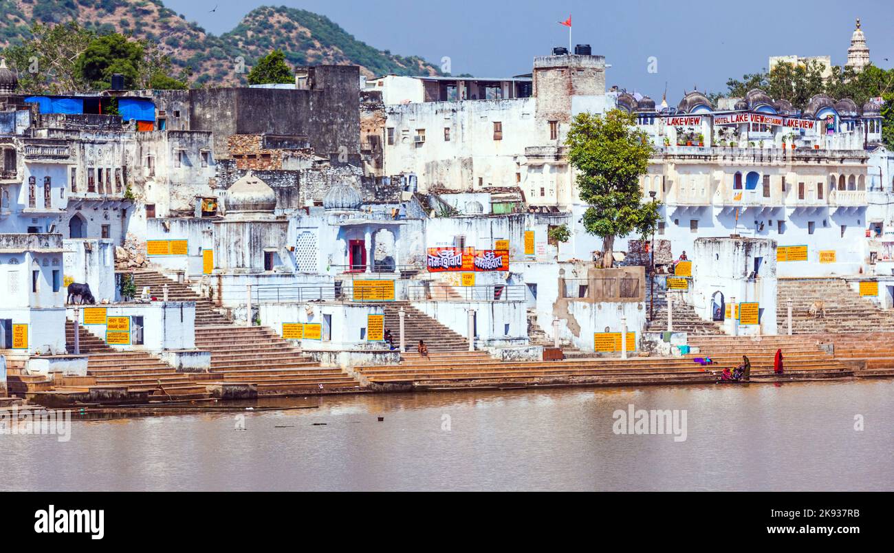 PUSHKAR, INDIA - OCTOBER 20, 2012: Pilgrims take ritual bathing in holy ...