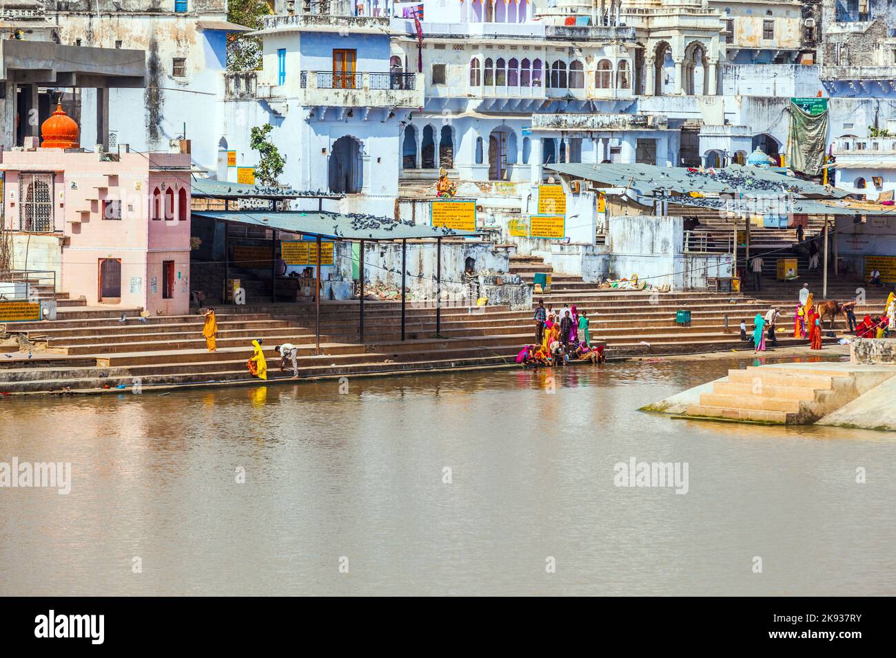 PUSHKAR, INDIA - OCTOBER 20, 2012: Pilgrims take ritual bathing in holy ...