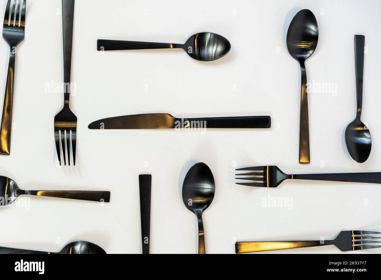 black metal forks and spoons on a white background, mexico Stock Photo ...