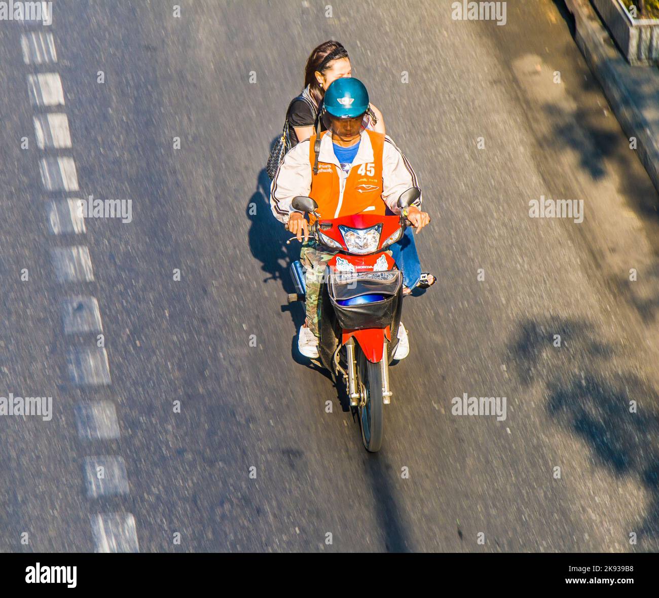 Woman in orange jacket rides hi-res stock photography and images - Alamy