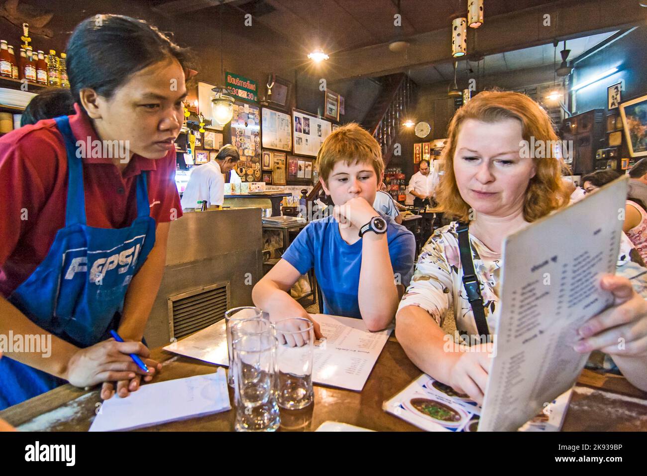 BANGKOK, THAILAND - JAN 9, 2008: family orders the meal in an old ...
