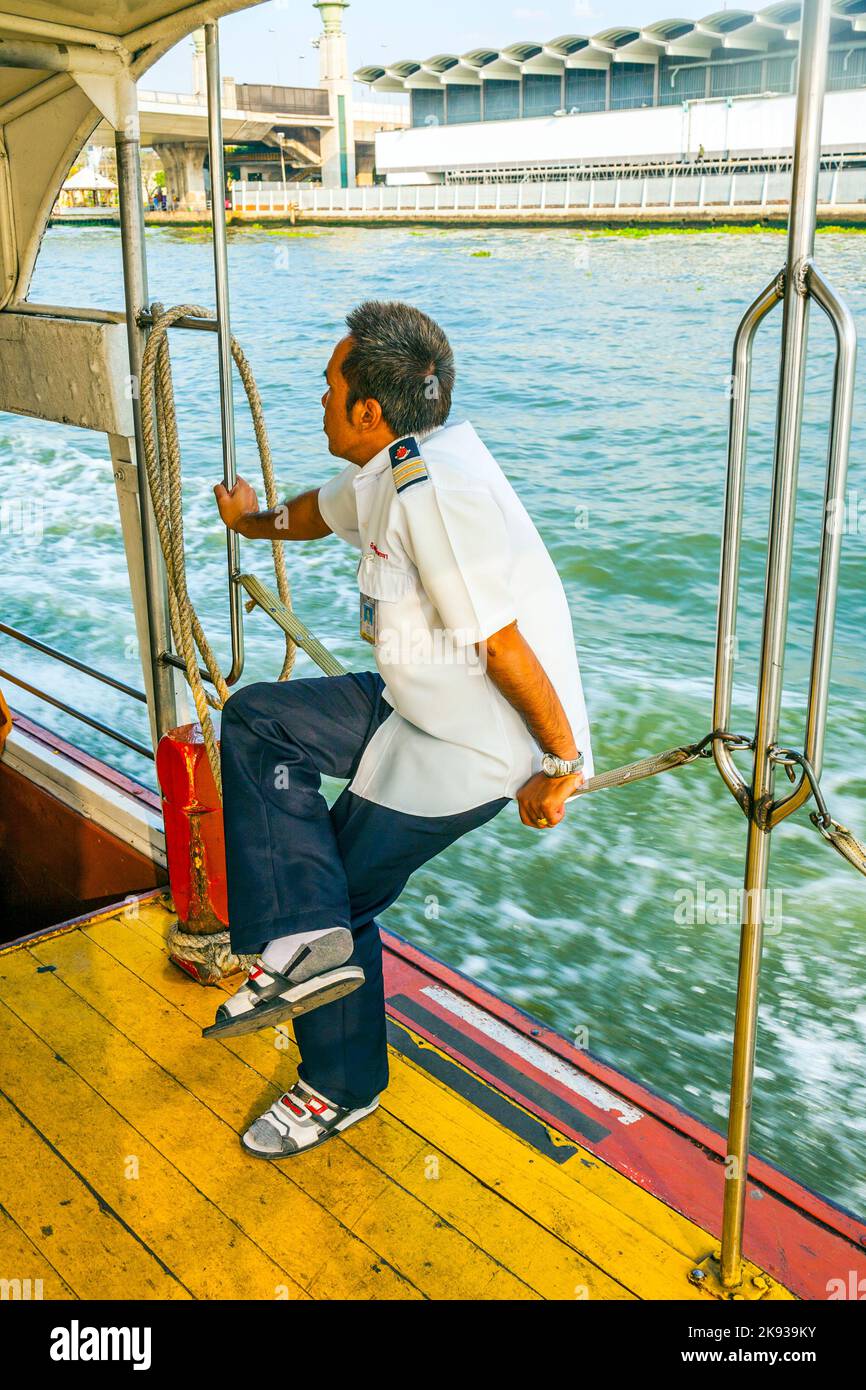 BANGKOK, THAILAND - DEC 23, 2009: captain sitting on the safety chain ...