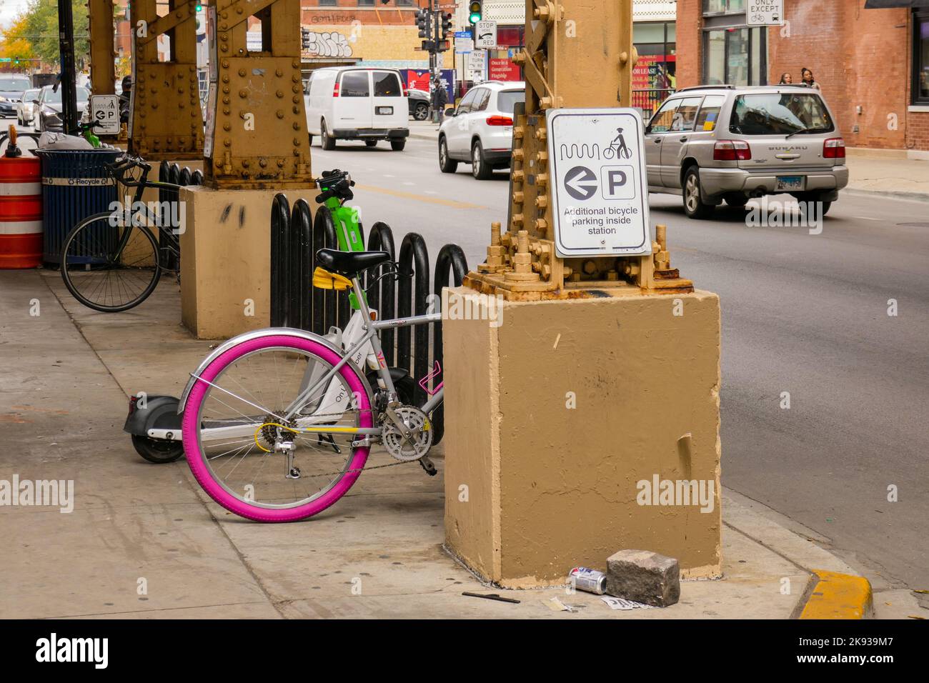 Bicycles and electric scooter locked at a bike rack under the CTA Blue ...
