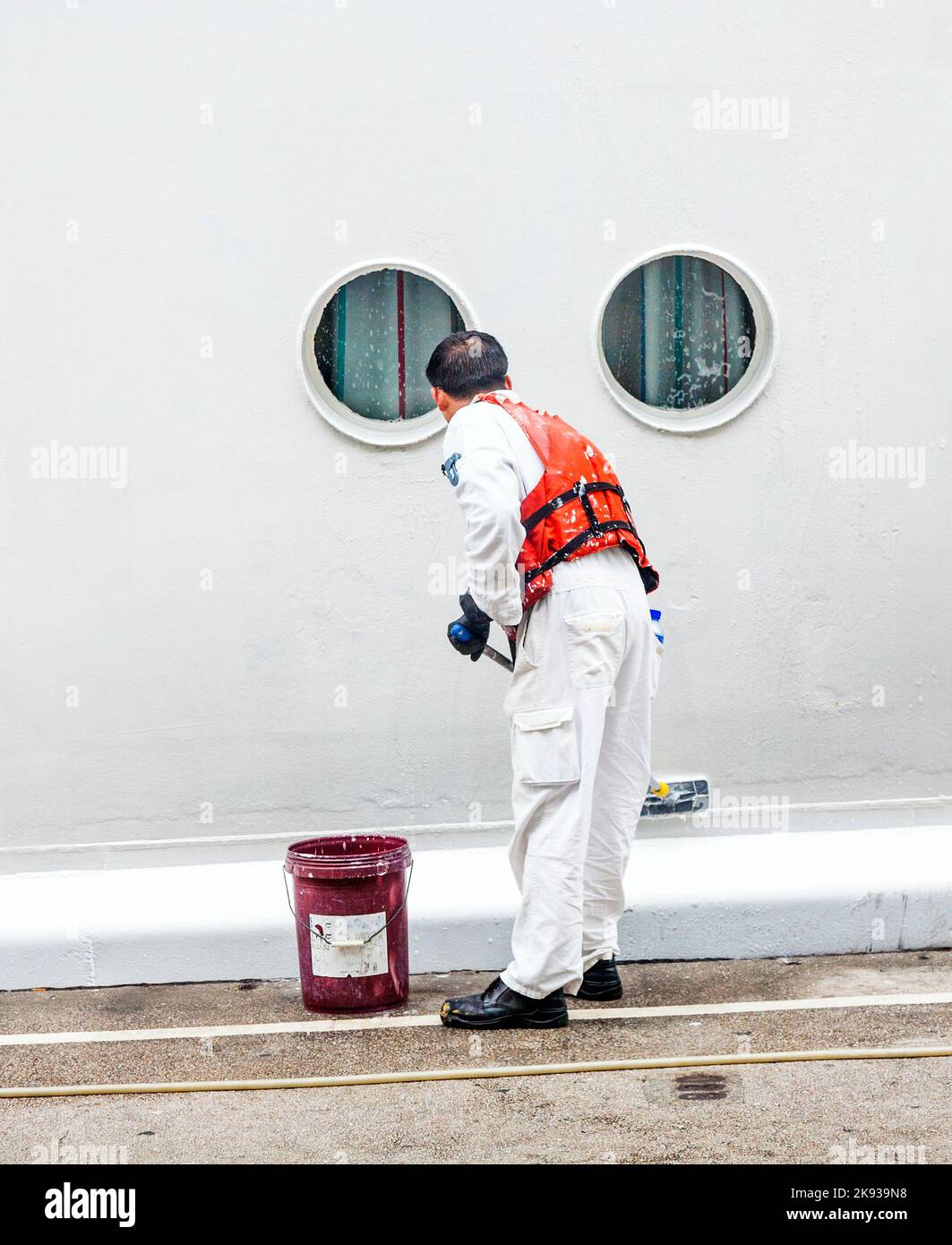 HONG KONG - JANUARY 8: worker clean the ship's side a cruiser on ...