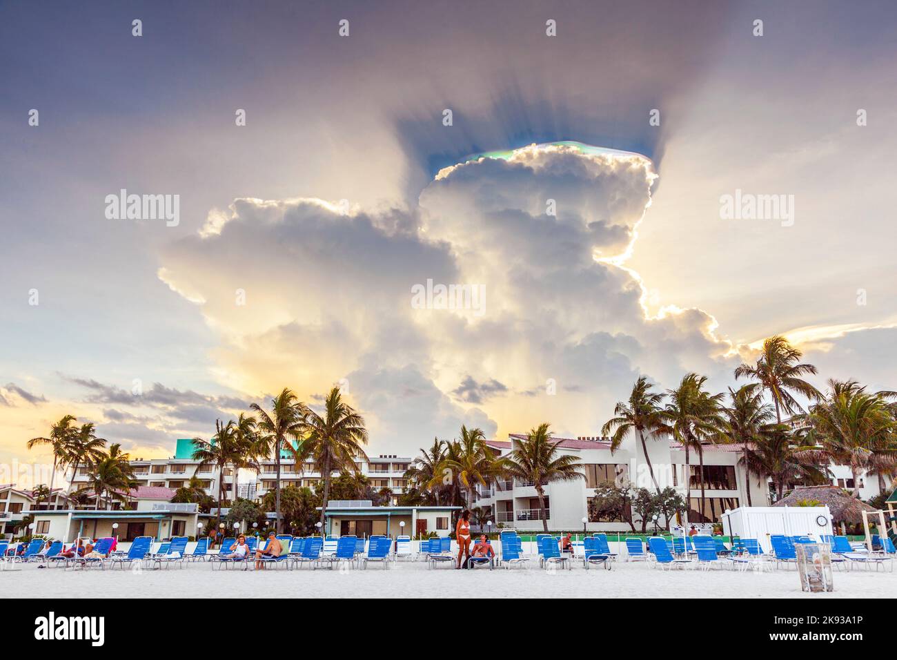 MIAMI, USA - JULY 30, 2010: people enjoy playing Volleyball im Miami, USA. Dark clouds with ...