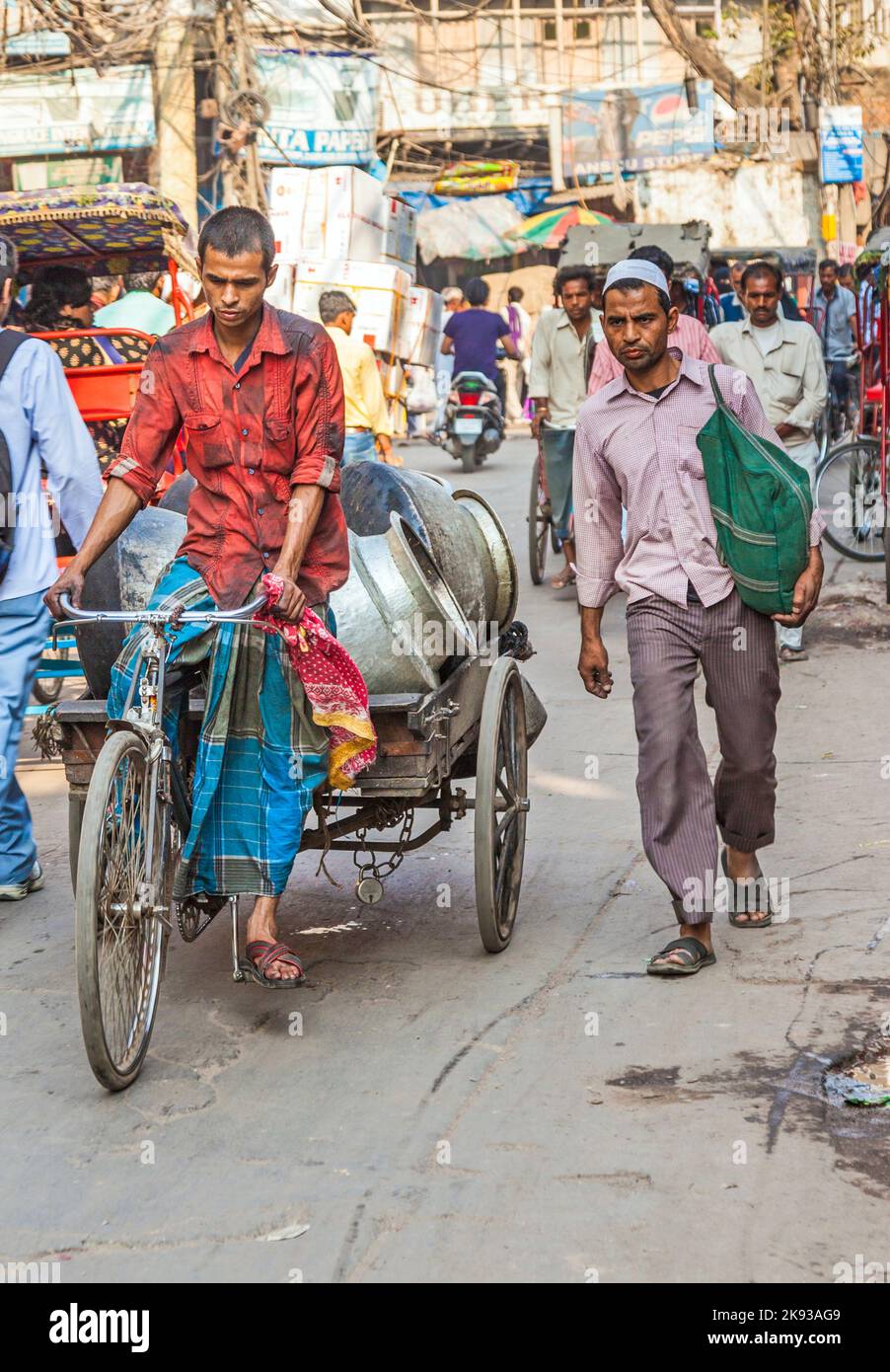 DELHI, INDIA - NOVEMBER 11, 2011: Cycle rickshaws with cargo load in ...