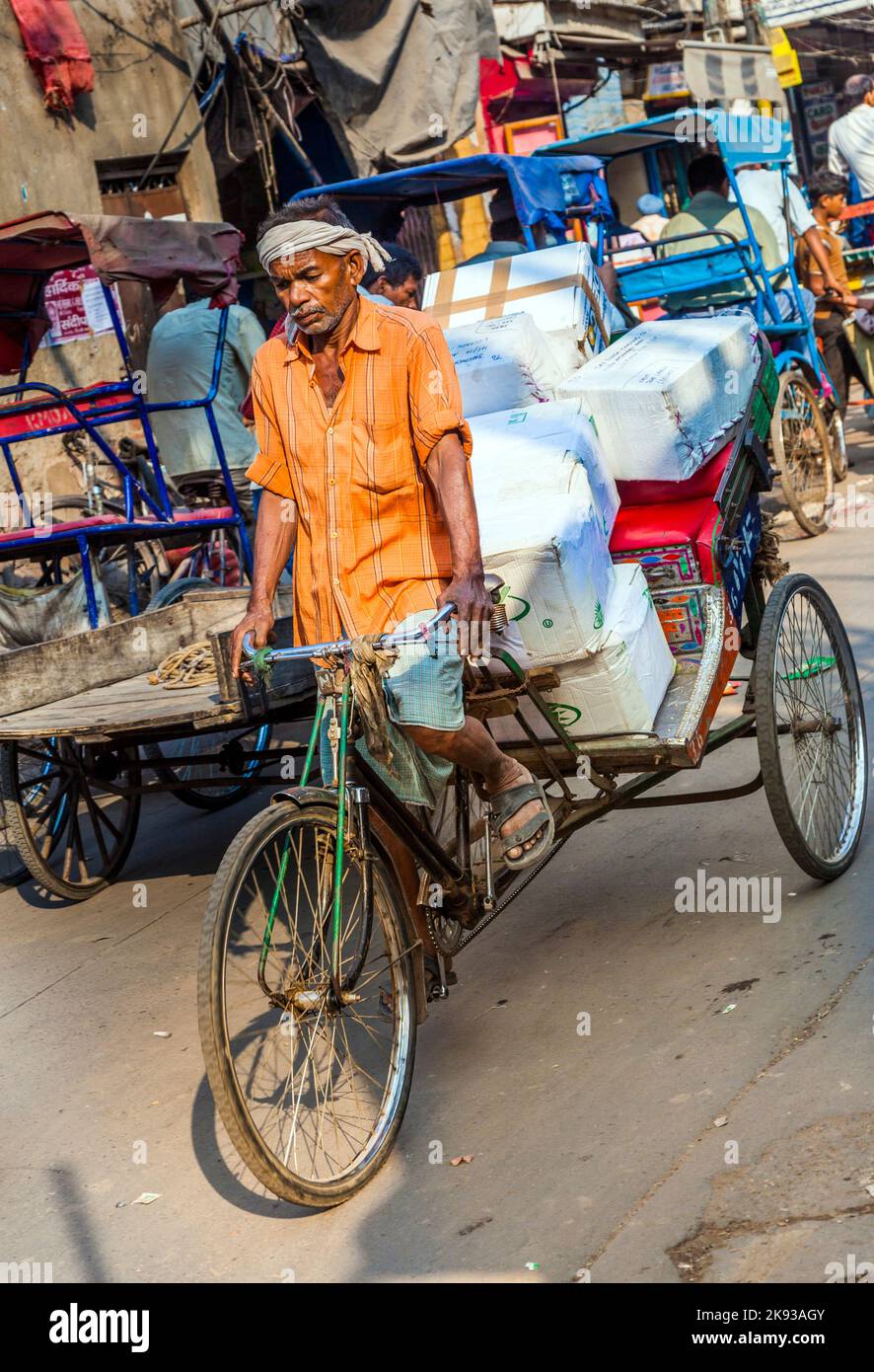 DELHI, INDIA - NOVEMBER 11, 2011: Cycle rickshaws with cargo load in ...