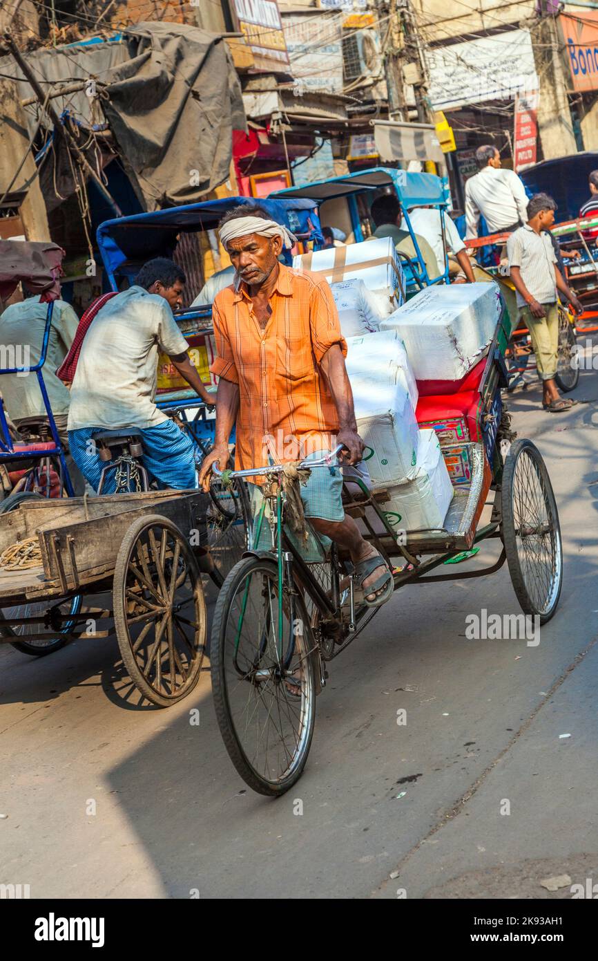 DELHI, INDIA - NOVEMBER 11, 2011: Cycle rickshaws with cargo load in ...