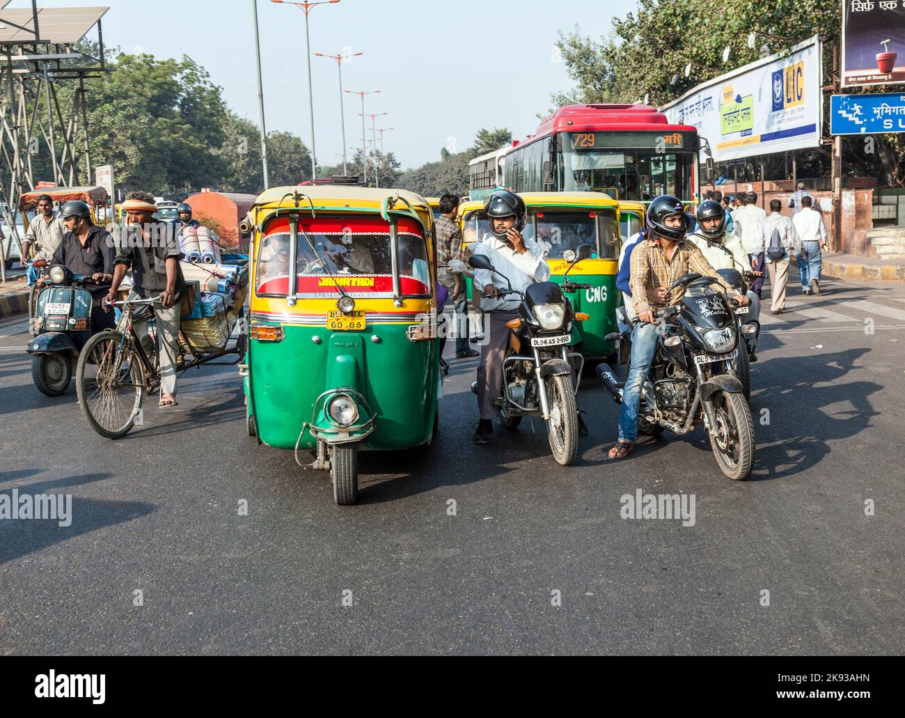 DELHI, INDIA - NOV 11, 2011: Transporting people through city on auto ...