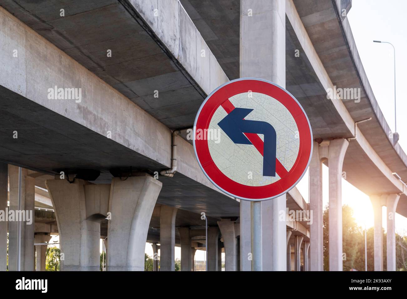 Turn left is prohibited. Traffic sign with crossed out arrow to the left Stock Photo - Alamy