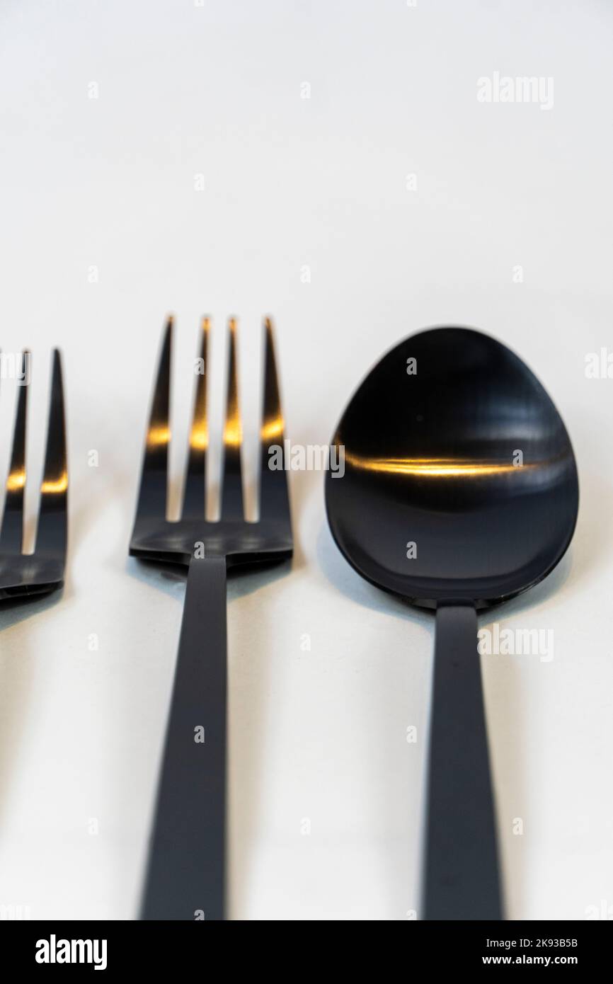 black metal forks and spoons on a white background, mexico Stock Photo ...