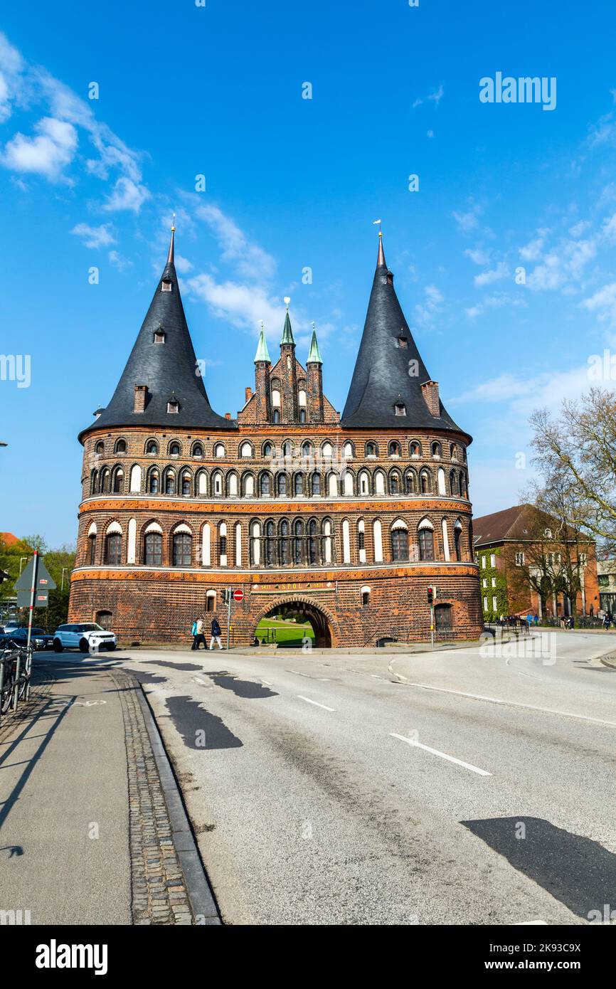 LUBECK, GERMANY - APRIL 22, 2014: People walk along Holstentor gate in ...