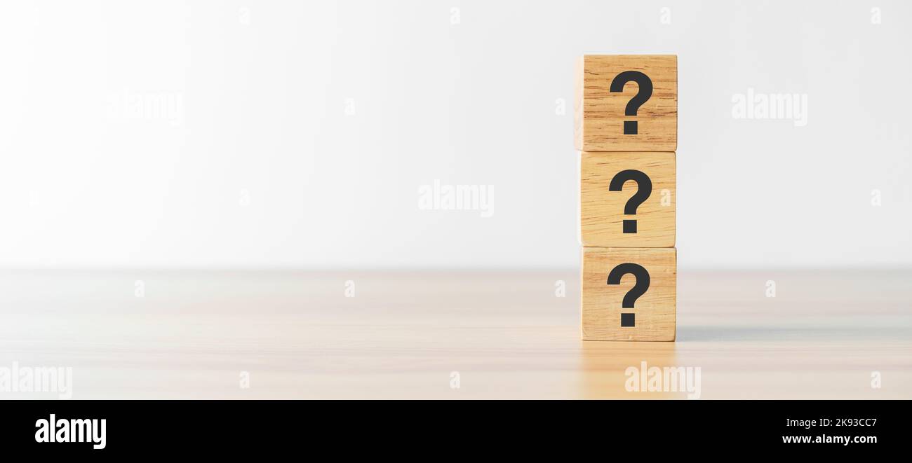 Questions Mark word with wood block on table background. FAQ, frequency ...