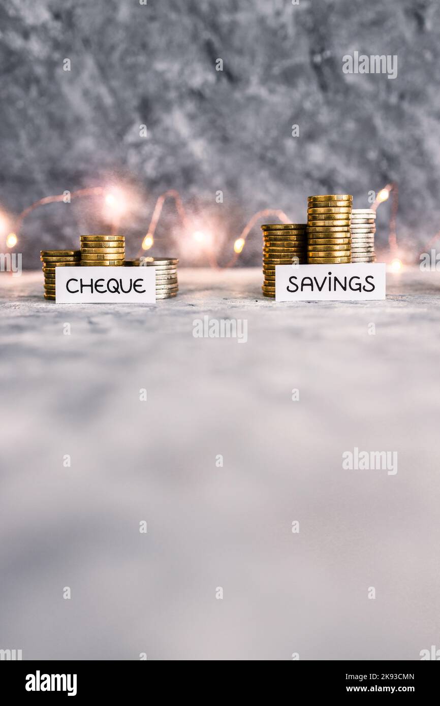 Cheque savings and credit account texts in front of growing stacks of ...