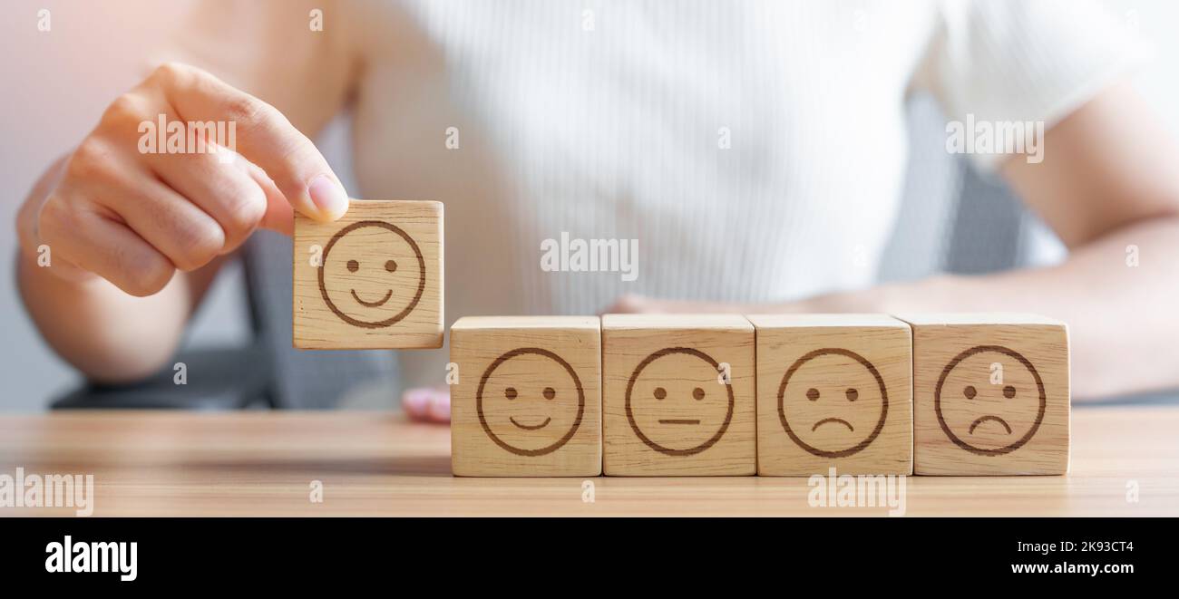 Hand choosing smile face from Emotion block for customer review, good ...
