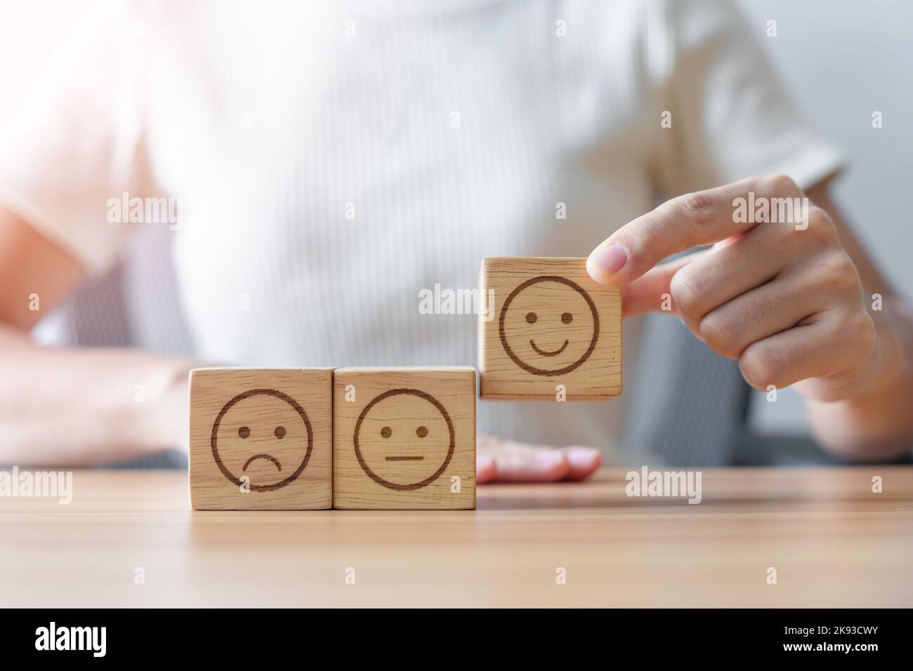 Hand choosing smile face from Emotion block for customer review, good ...