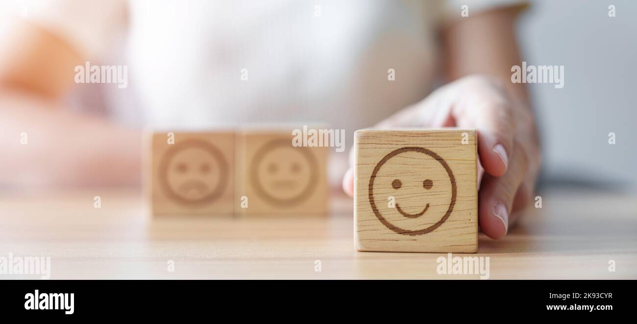 Hand choosing smile face from Emotion block for customer review, good ...