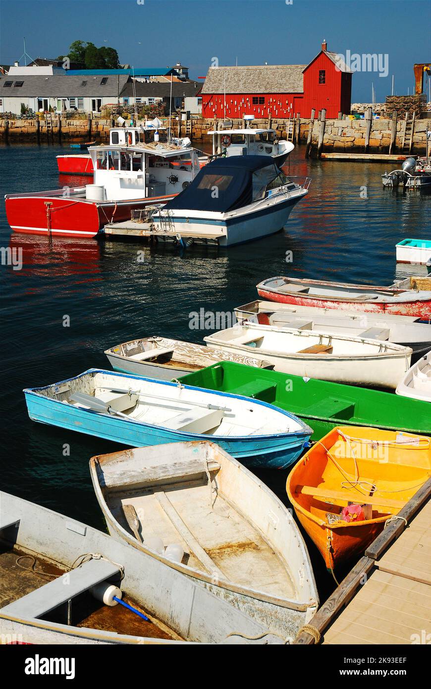A Group Of Dinghies Are Tied To The Dock Near The Working Lobster Boats