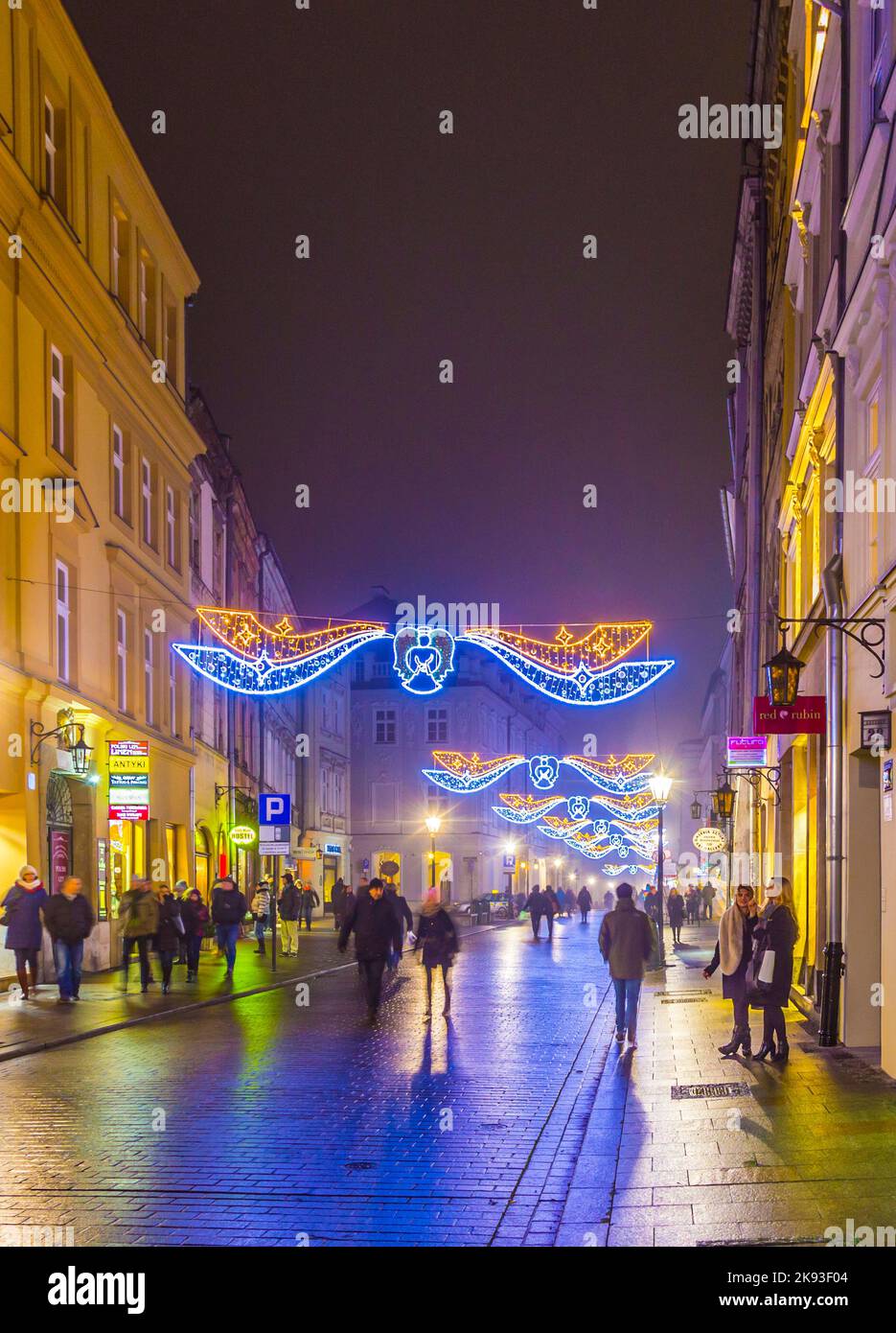 KRAKOW, POLAND - DECEMBER 5, 2014: City center by night: people at ...