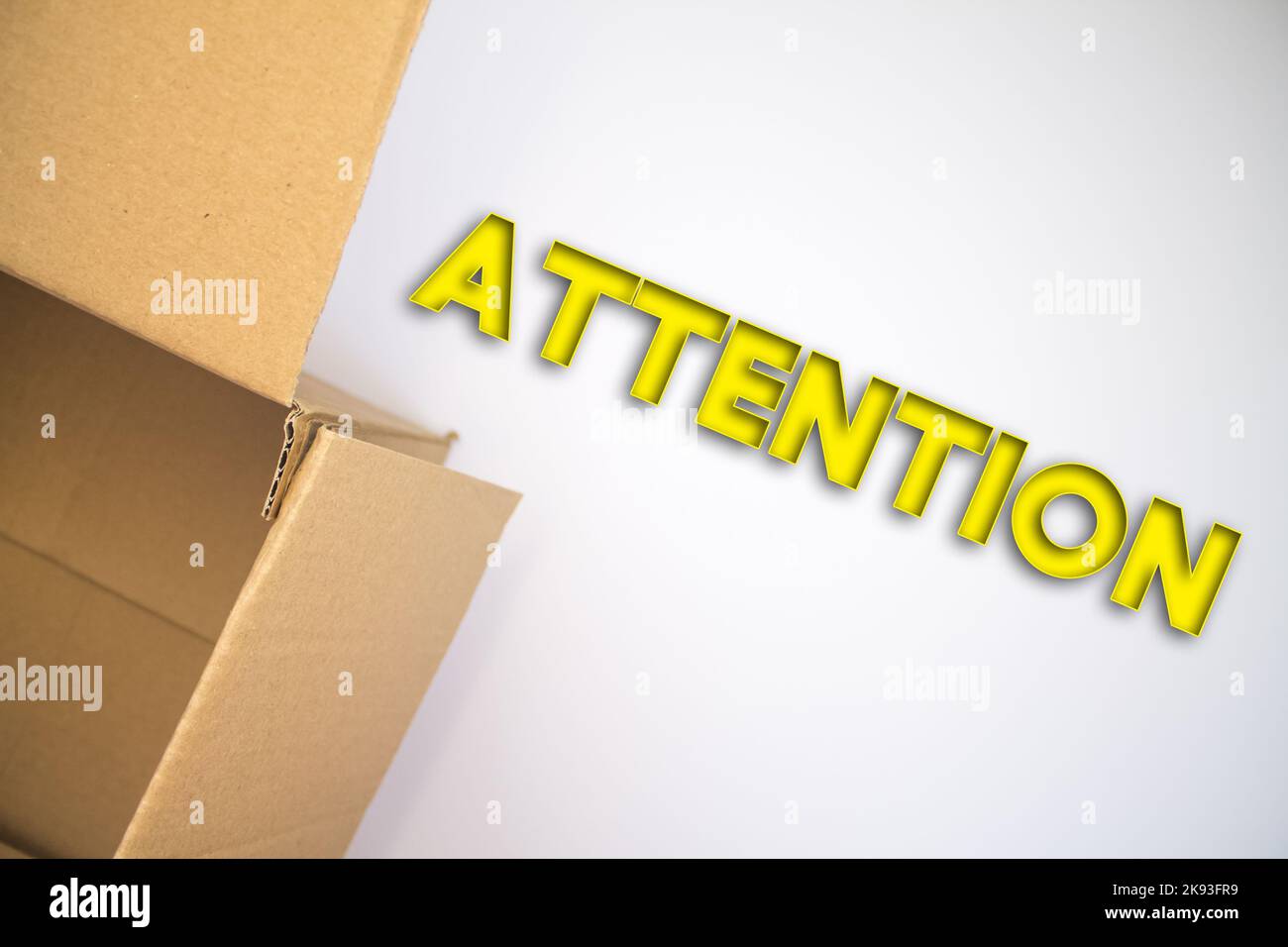 Attention word with cardboard box. Brown folded card box Stock Photo ...